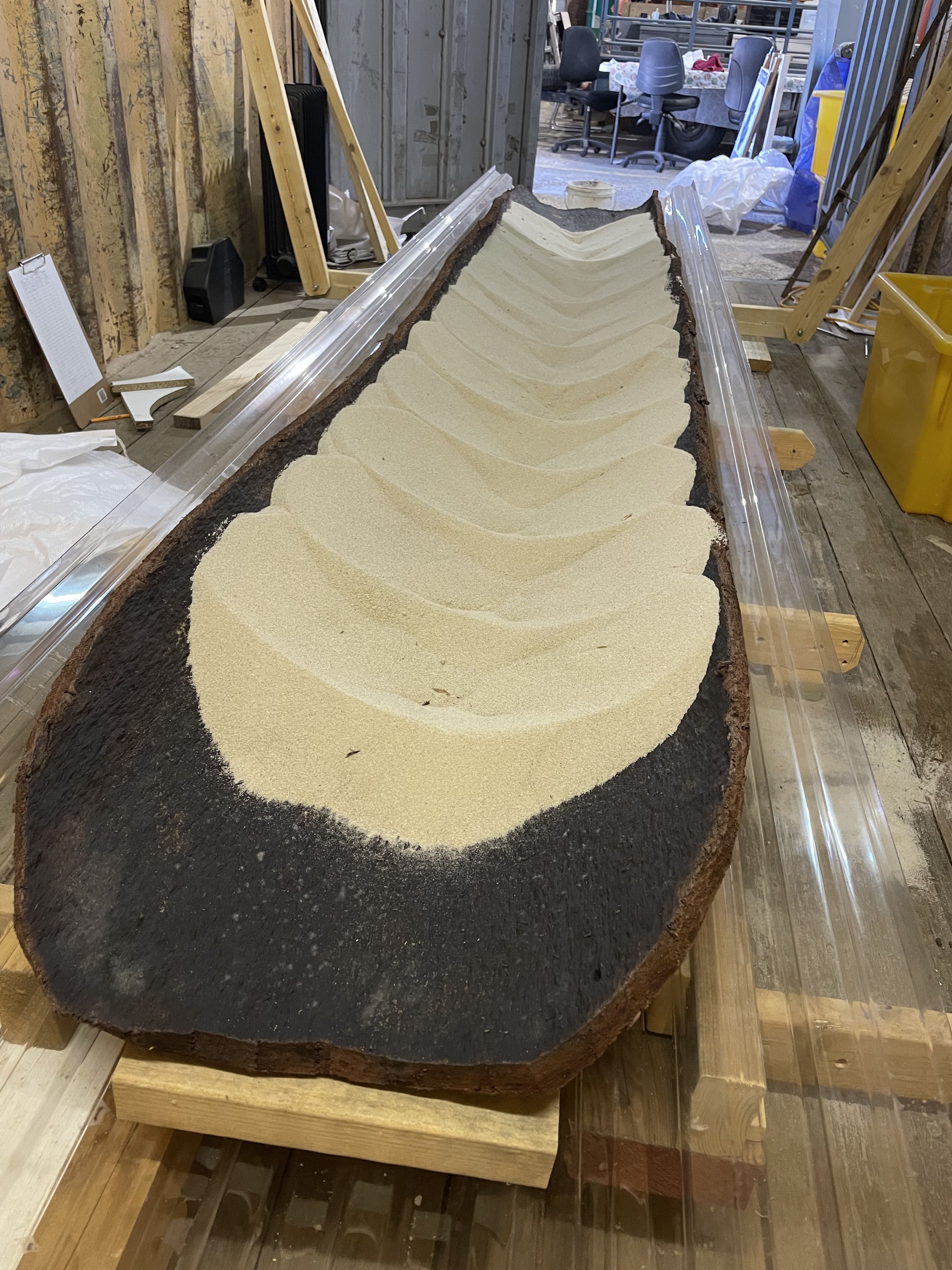 A piece of bark - the yuki- is sitting on a wooden frame and a plastic ...